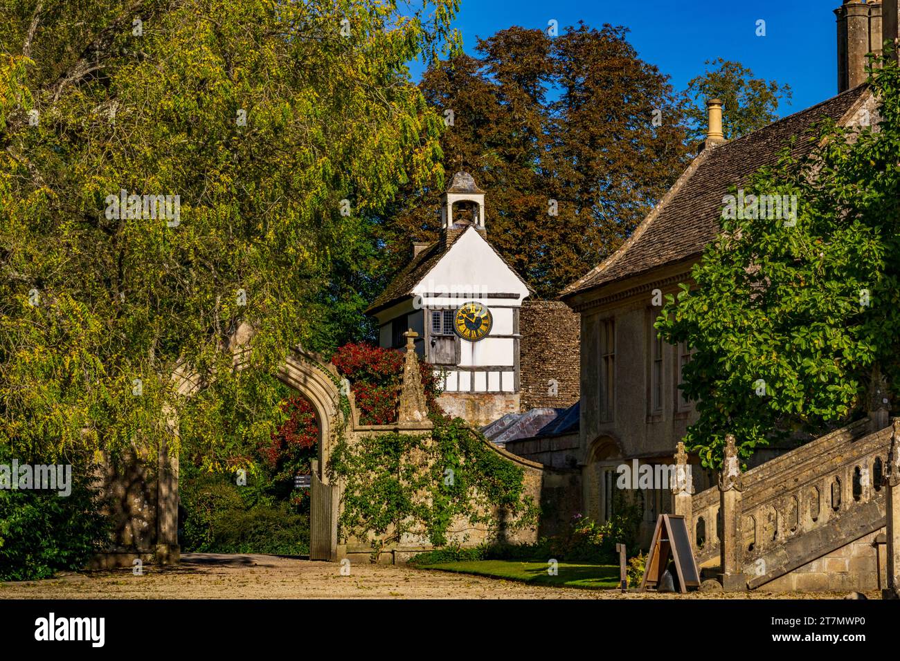 The tudor-style architecture of the courtyard and clock tower at Lacock ...