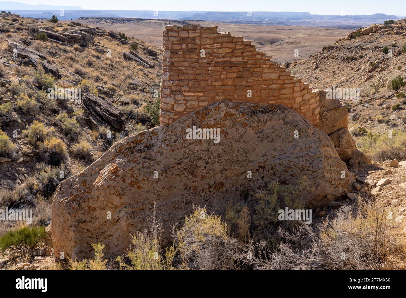Ruins of a tower perched on a tilted boulder in the Ancestral Puebloan ...