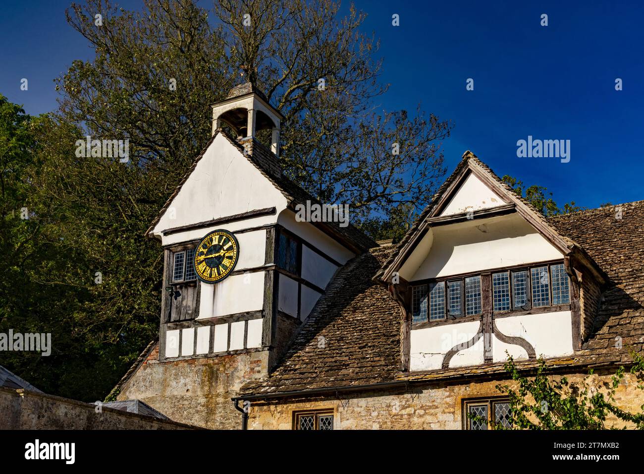 The tudor-style architecture of the courtyard and clock tower at Lacock ...