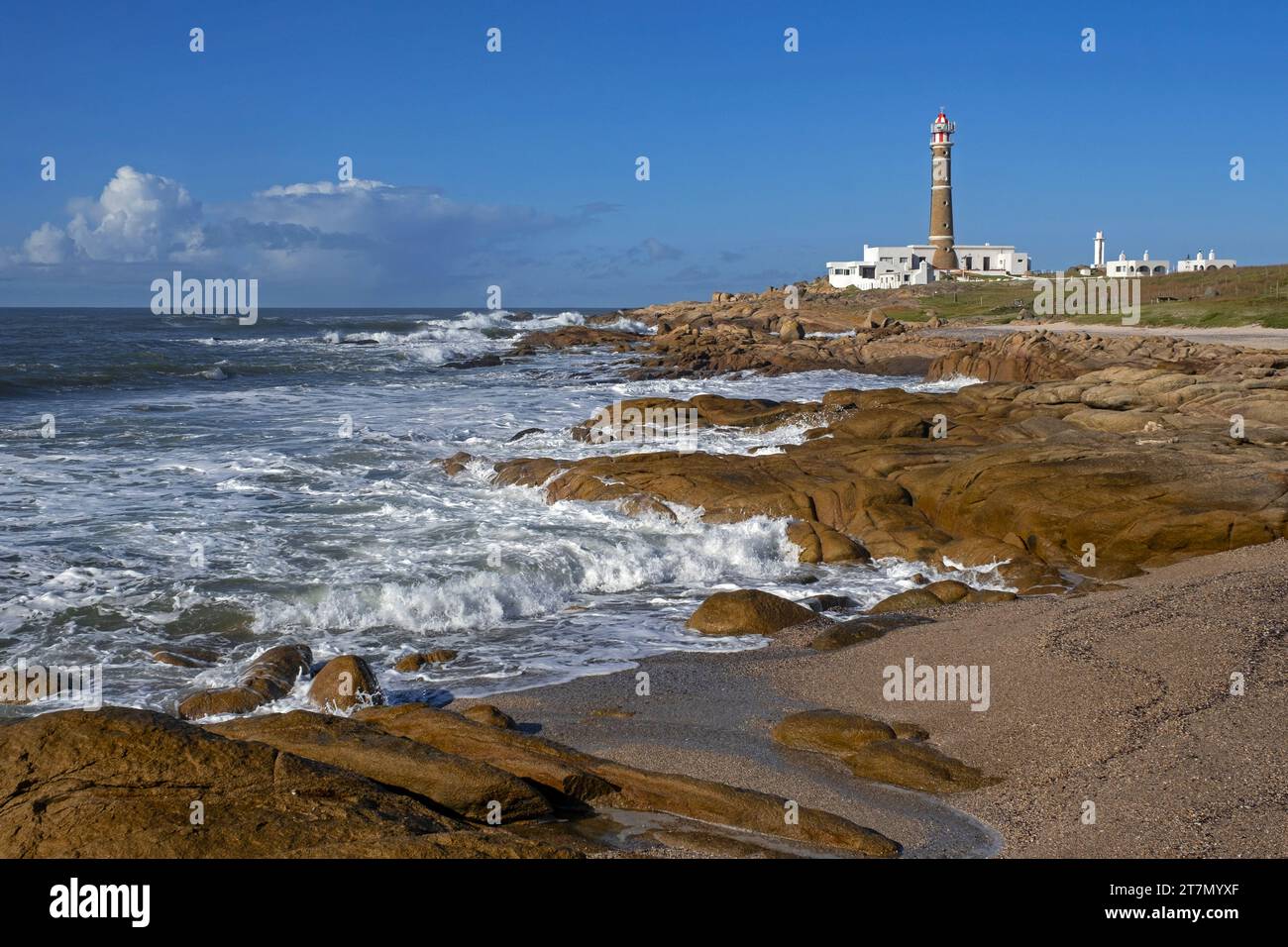Rocky shore and lighthouse at Cabo Polonio along the Atlantic Ocean coast, Rocha Department ...