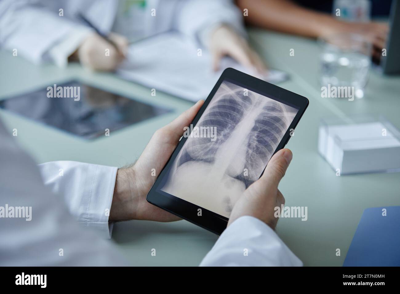 Close up of unrecognizable doctor holding digital tablet with chest X ...