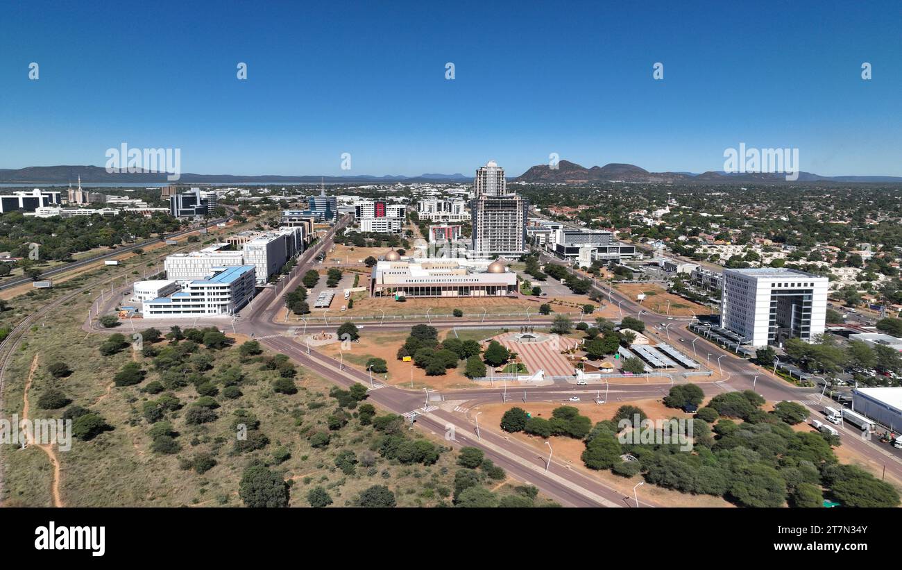 An aerial view of a bustling cityscape with lush vegetation alongside its streets, Gaborone ...