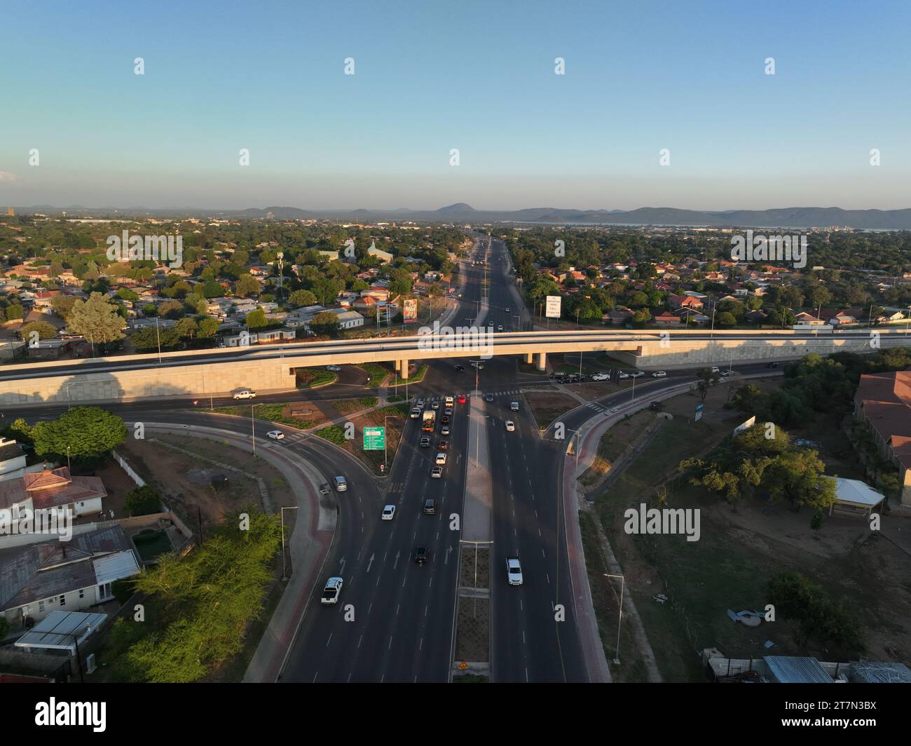 An aerial view of a bustling highway running between residential ...