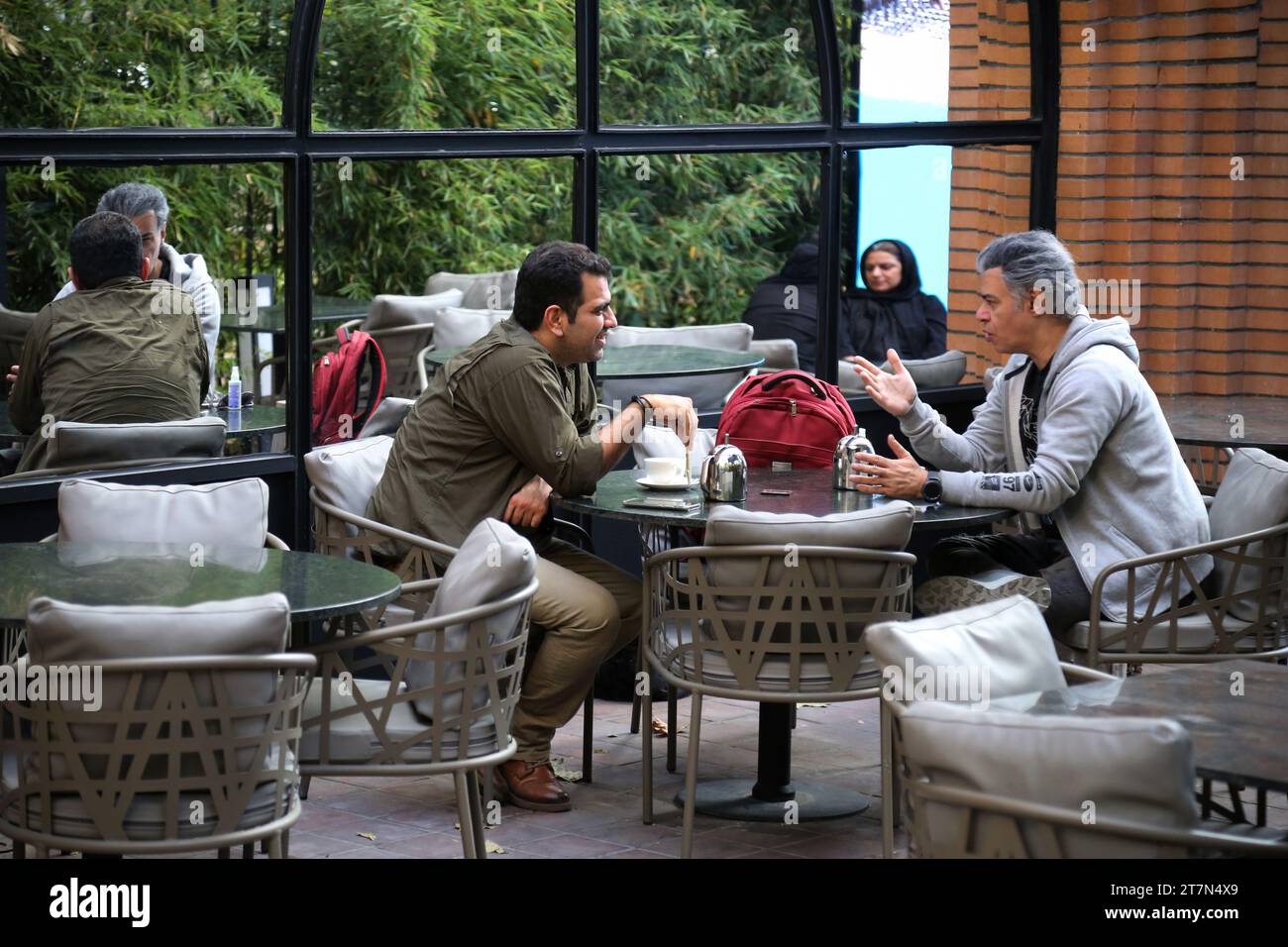 Tehran, Iran. 16th Nov, 2023. Two Iranian men spend their time at a ...