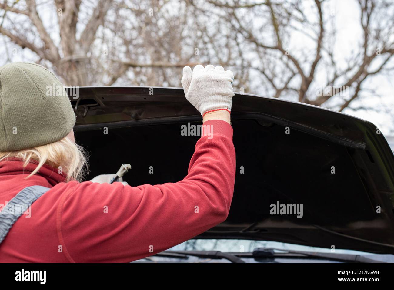 A man opens the hood of a car. Machine breakdown and repair Stock Photo ...