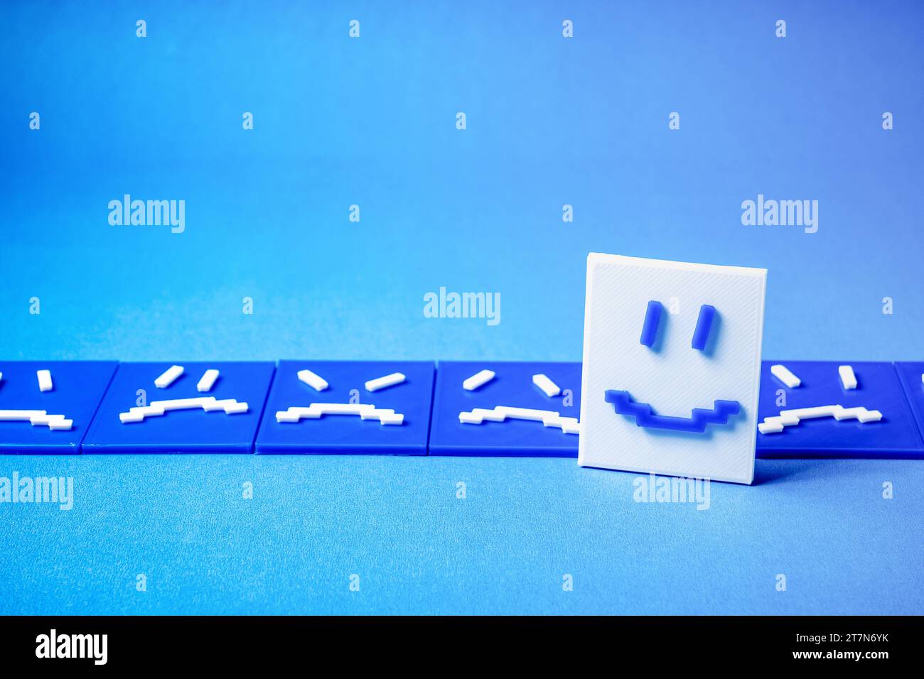 Concept of a happy face around sad and angry faces Stock Photo - Alamy