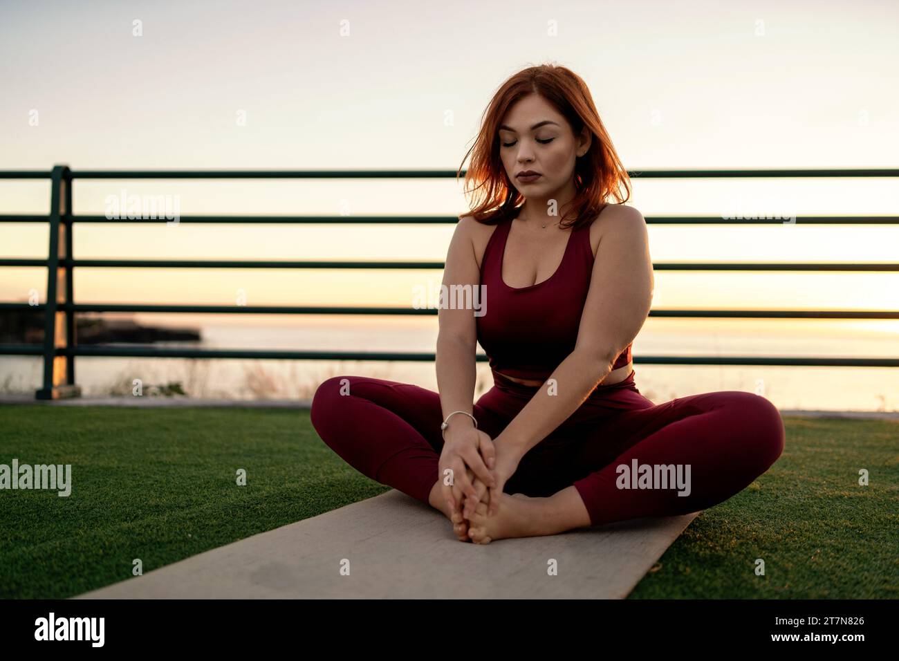 Curvy woman practices yoga by the sea, embracing serenity and ...