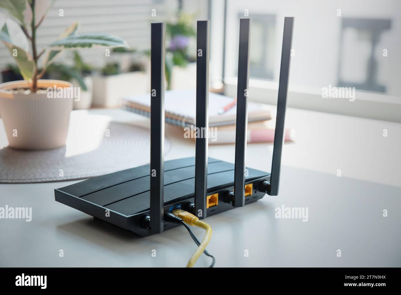 Modern wi-fi router on light table in room. High speed internet concept ...