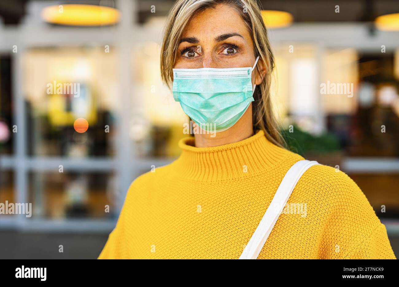 Woman in yellow sweater wearing hi-res stock photography and images - Alamy