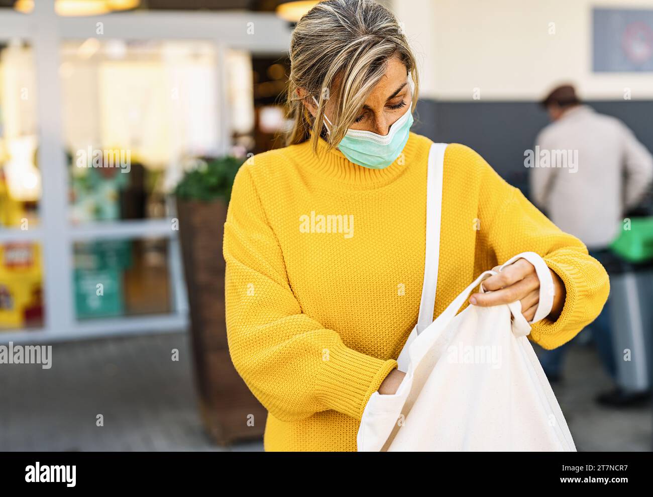 Woman in face mask checking hi-res stock photography and images - Alamy