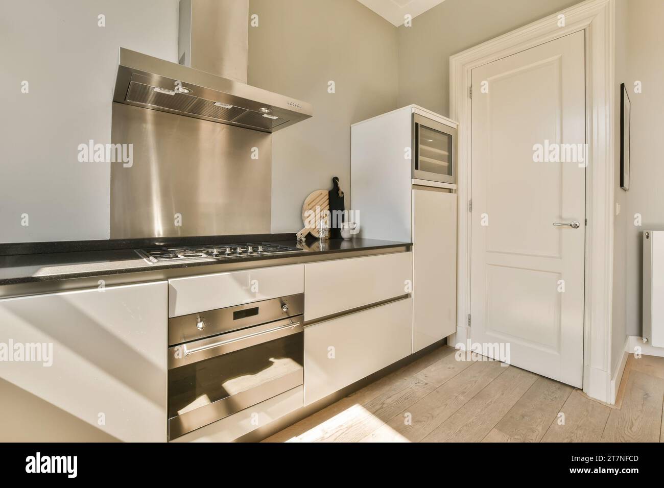 a kitchen with white cabinets and stainless steel appliances on the ...