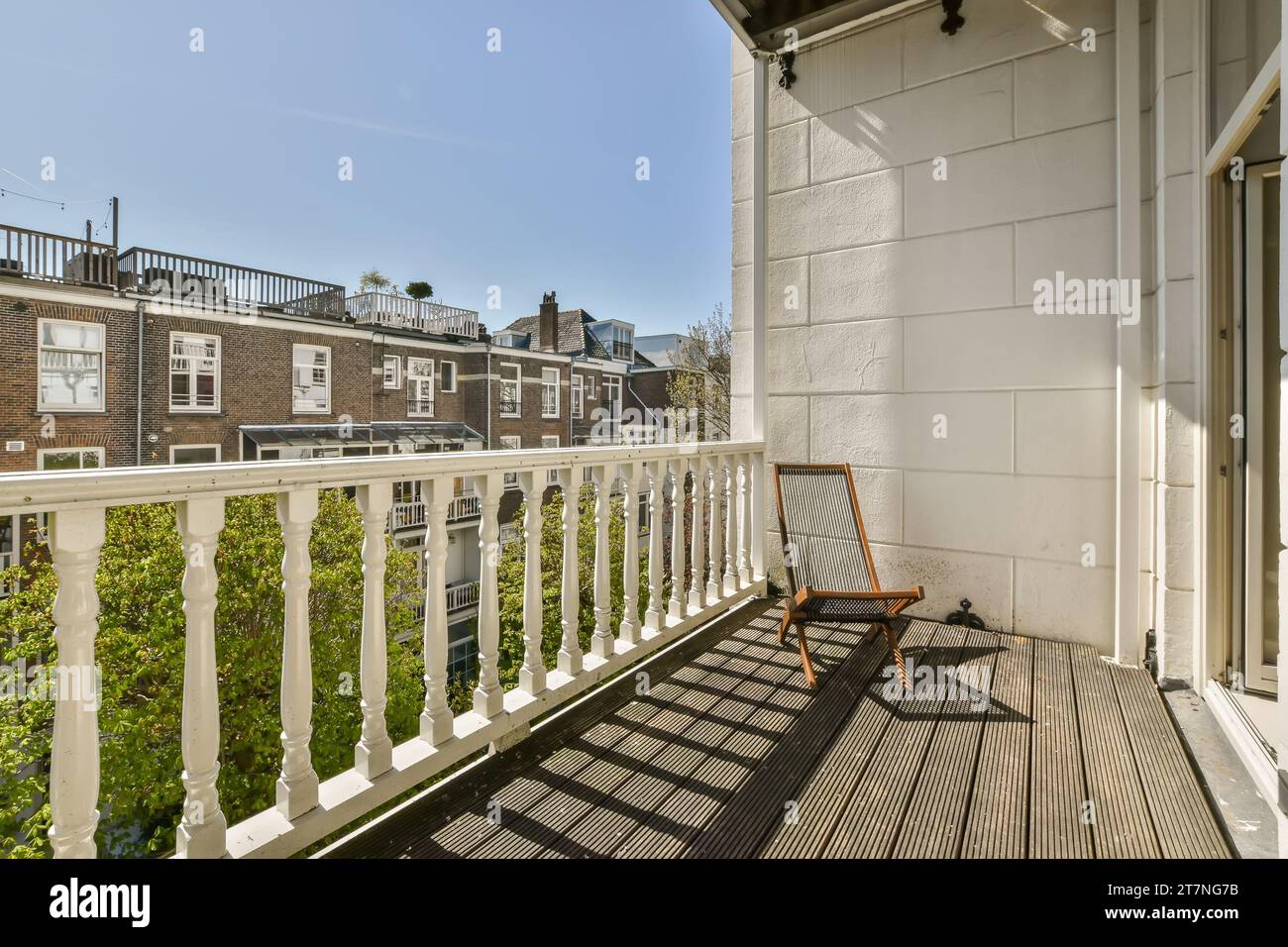 a balcony with white railings and green plants on the balknotn, london ...
