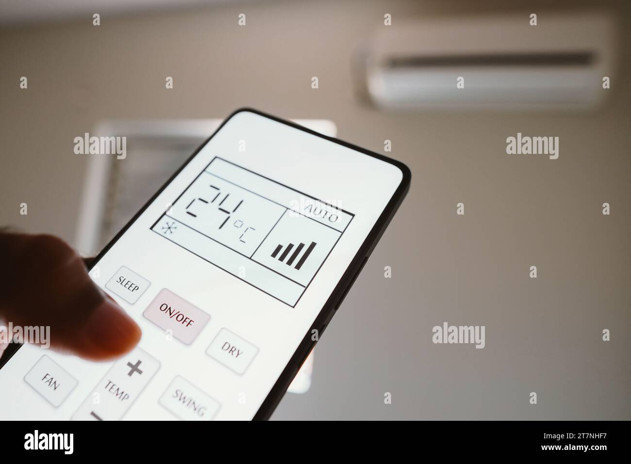 In this photo illustration, a person adjusts the room temperature of ...