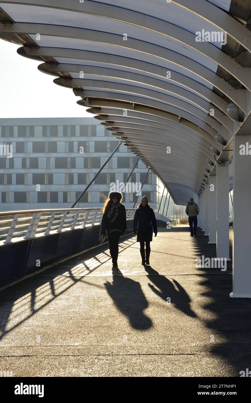 Two women dressed for winter on the Bell's Bridge across the river ...