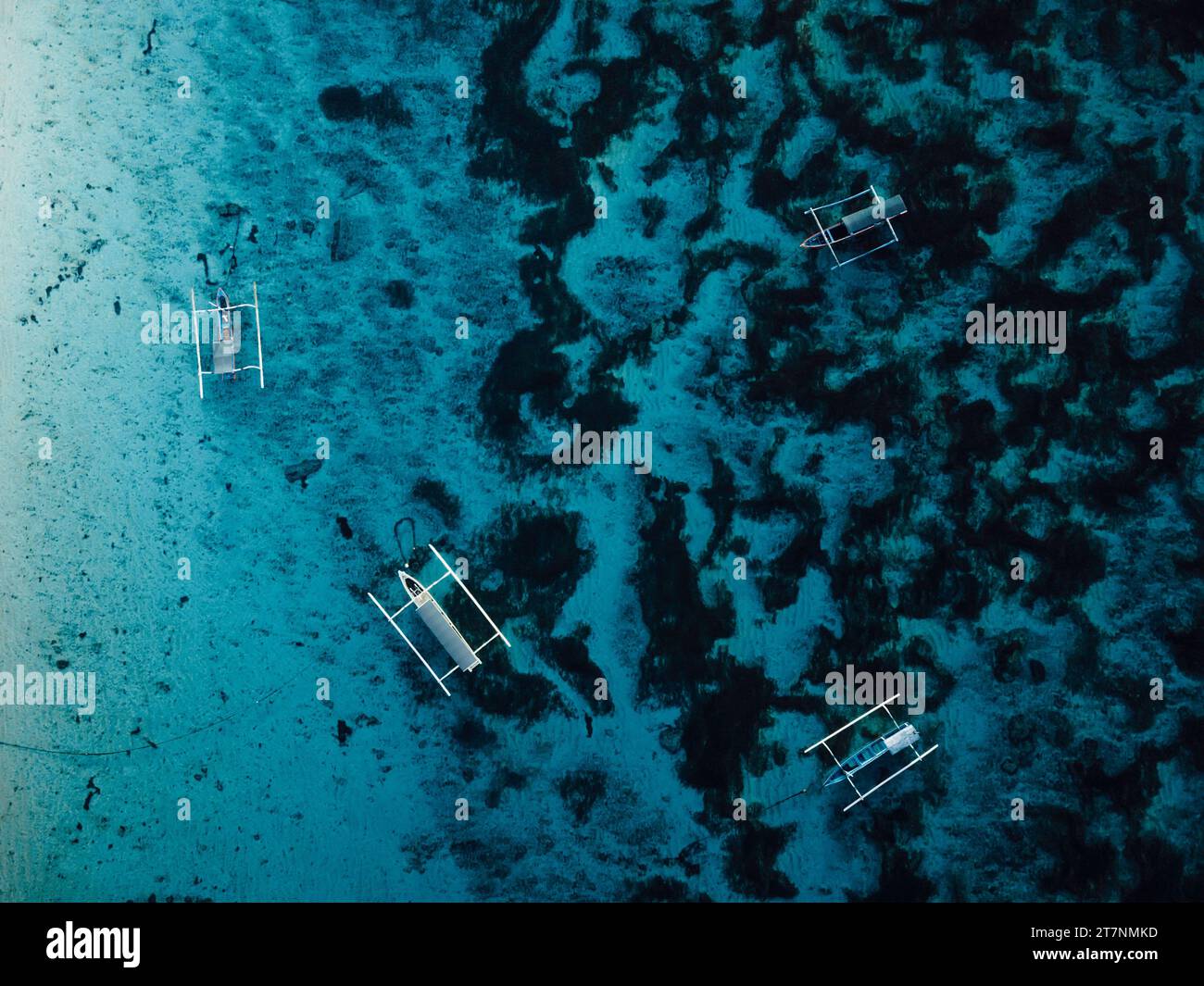 Fishing boats at anchor in blue transparent ocean on tropical island ...
