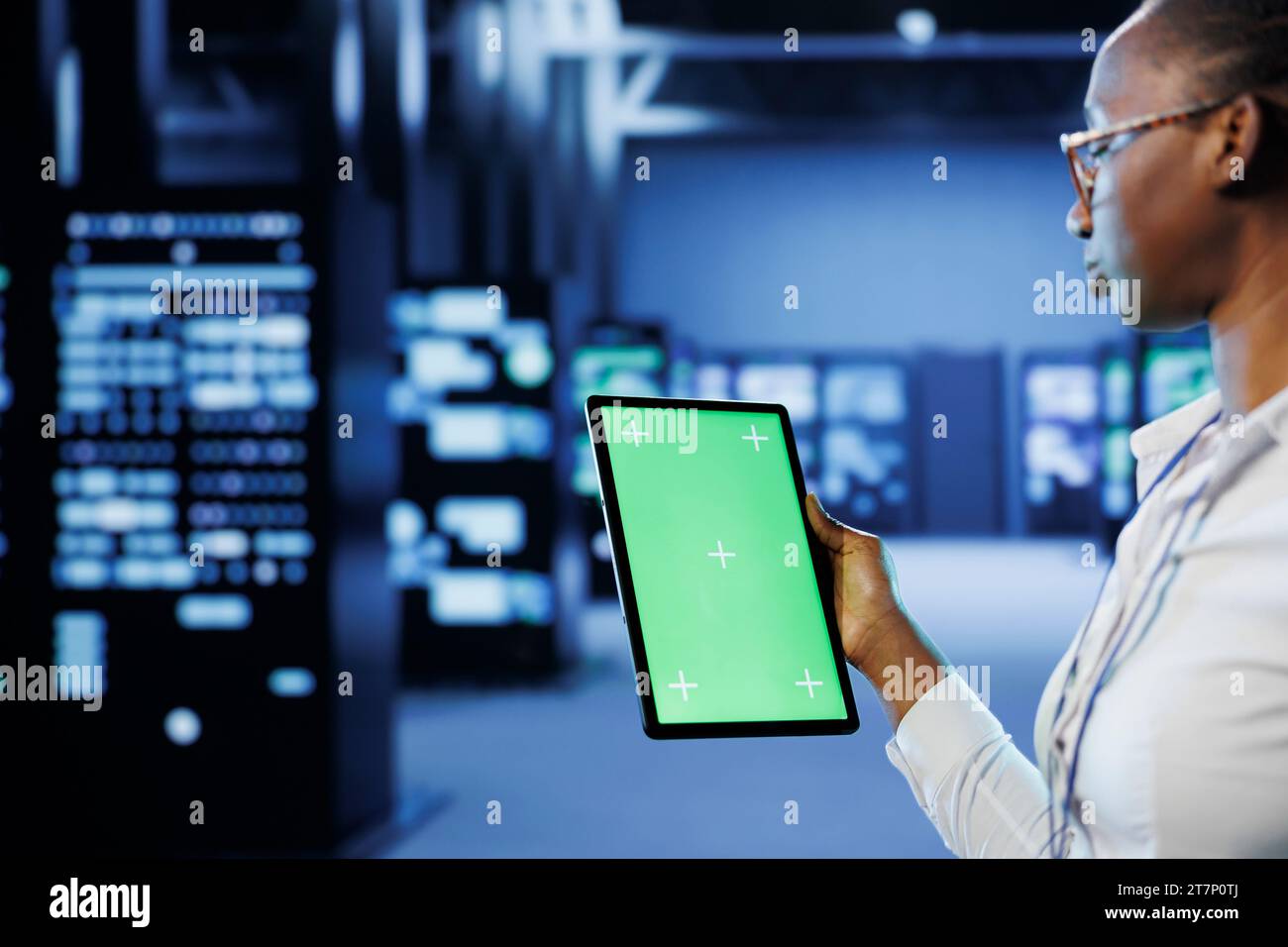 Technician in server room using green screen tablet to future proof ...