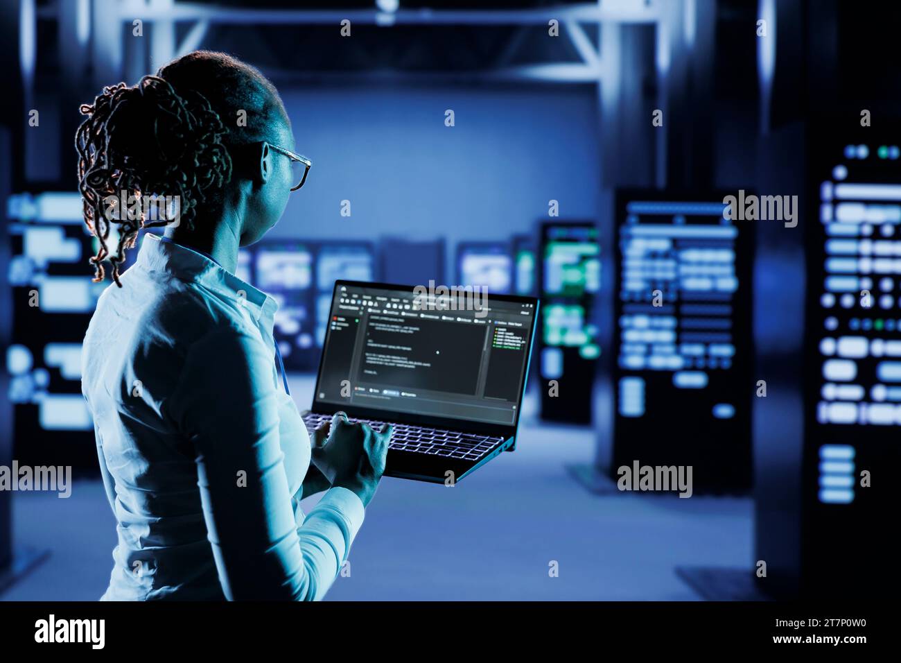 Experienced specialist running code and programming on laptop, troubleshooting and upgrading ...