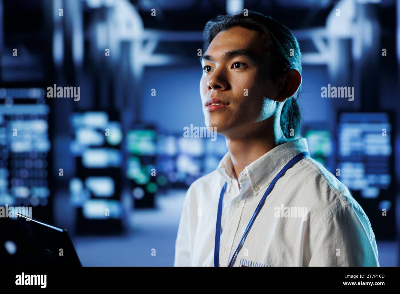 Certified technician in data center uses laptop to prevent system ...