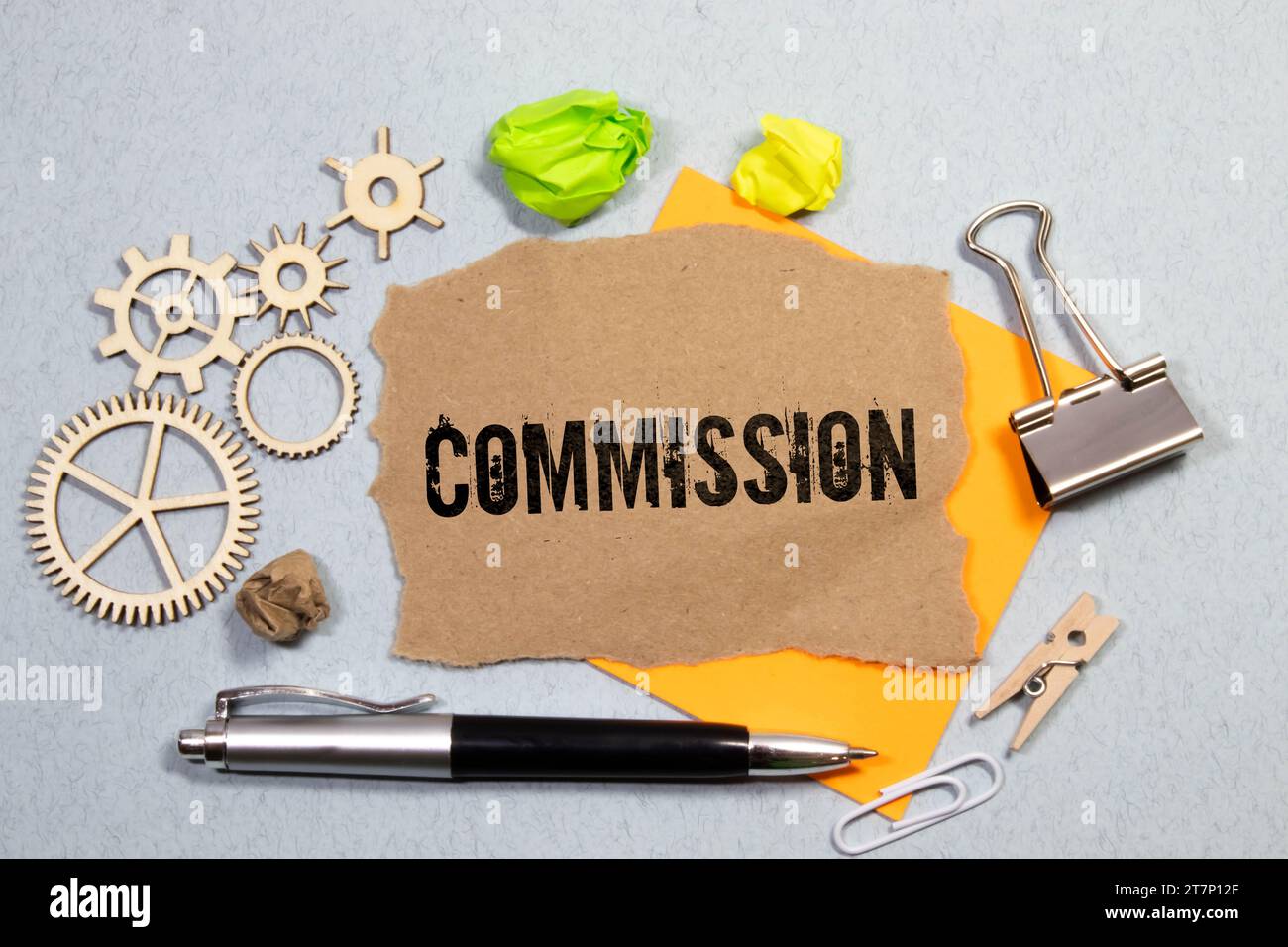 On the desktop are notebooks, a pen and a red folder for papers with ...