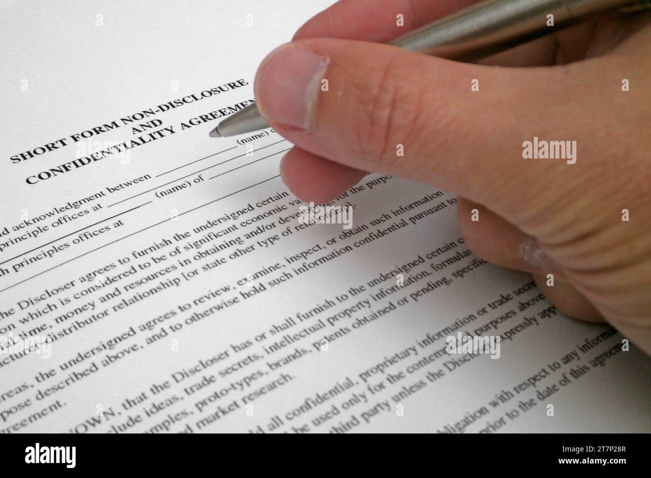 Close-up on a the hand of a man feeling a "Short form non-disclosure ...