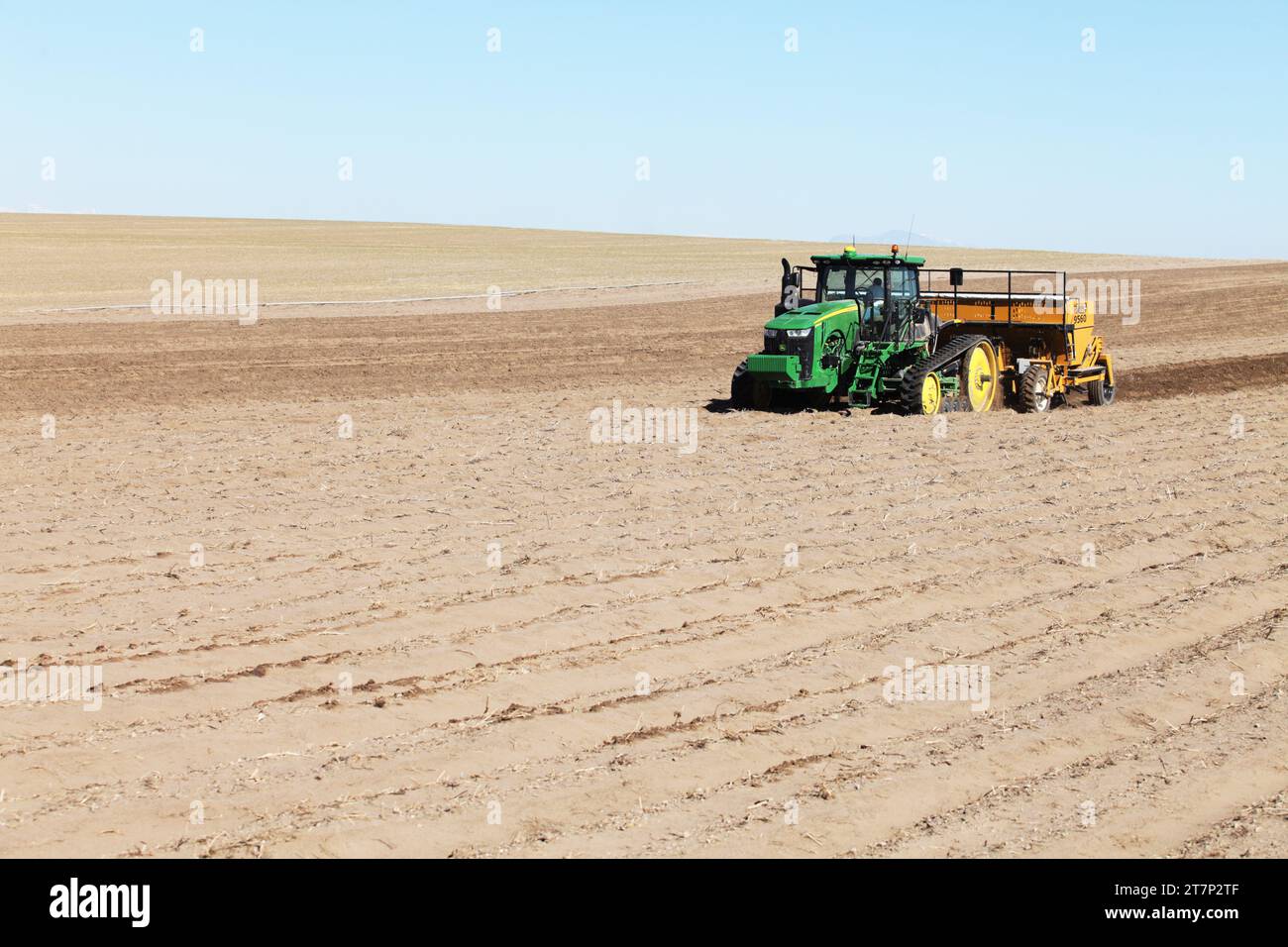 A tractor with planting implements, work in the fertile farm fields of ...