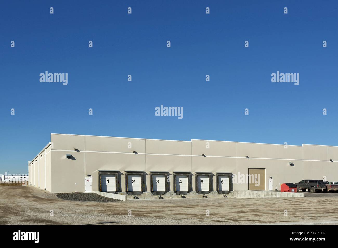 Six truck docks on the exterior of a modern tilt up concrete ...