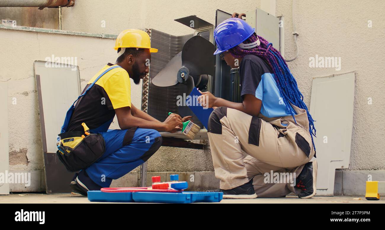 African american workers sweeping away loose debris accumulated around ...