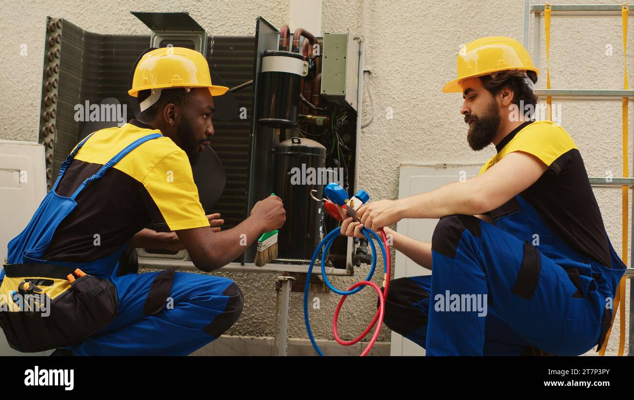 Knowleadgeable engineers assembling professional pressure indicator to check liquids and gases ...