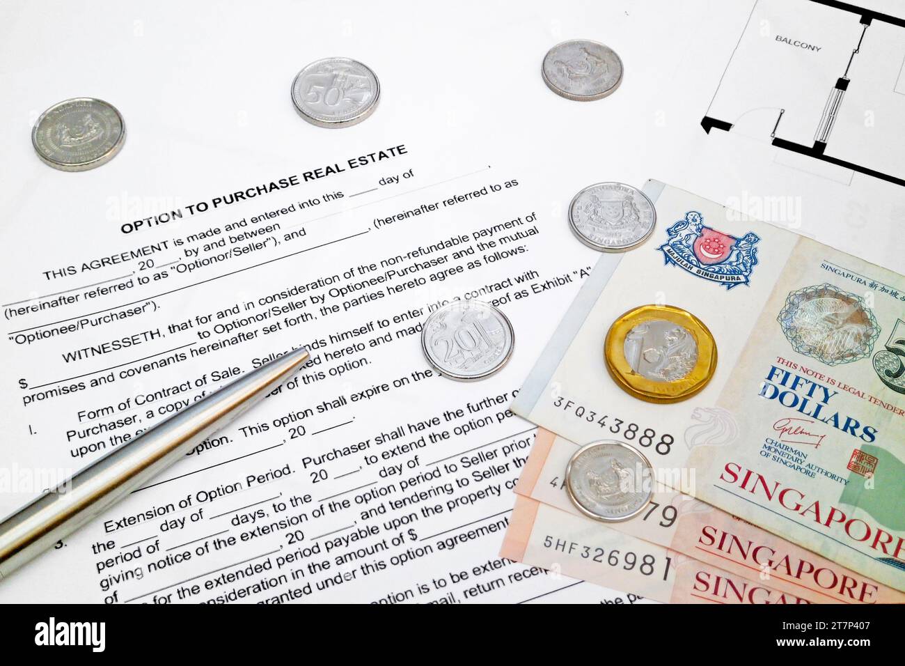 Close-up on a pen and some Singaporean coins and banknotes on the top ...