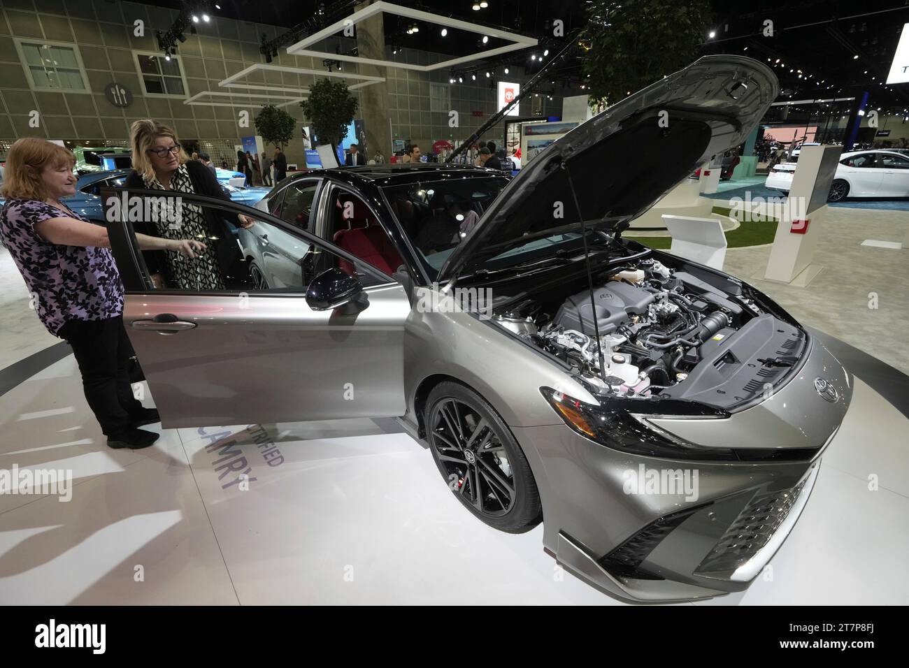 People look inside the Toyota Camry 2025 AWD HEV XSE model at the AutoMobility LA Auto Show ...