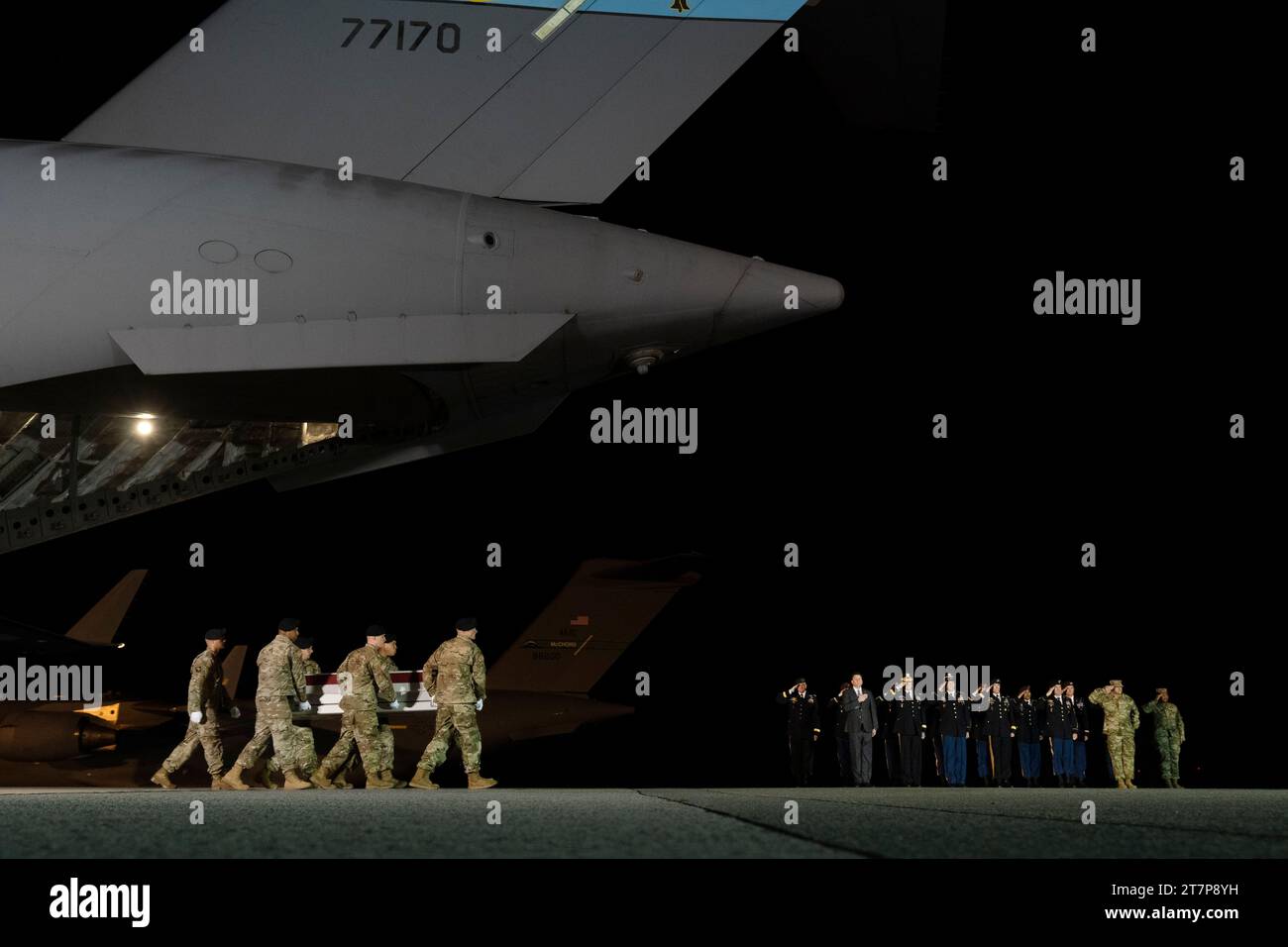 An Army carry team moves the transfer case containing the remains of ...