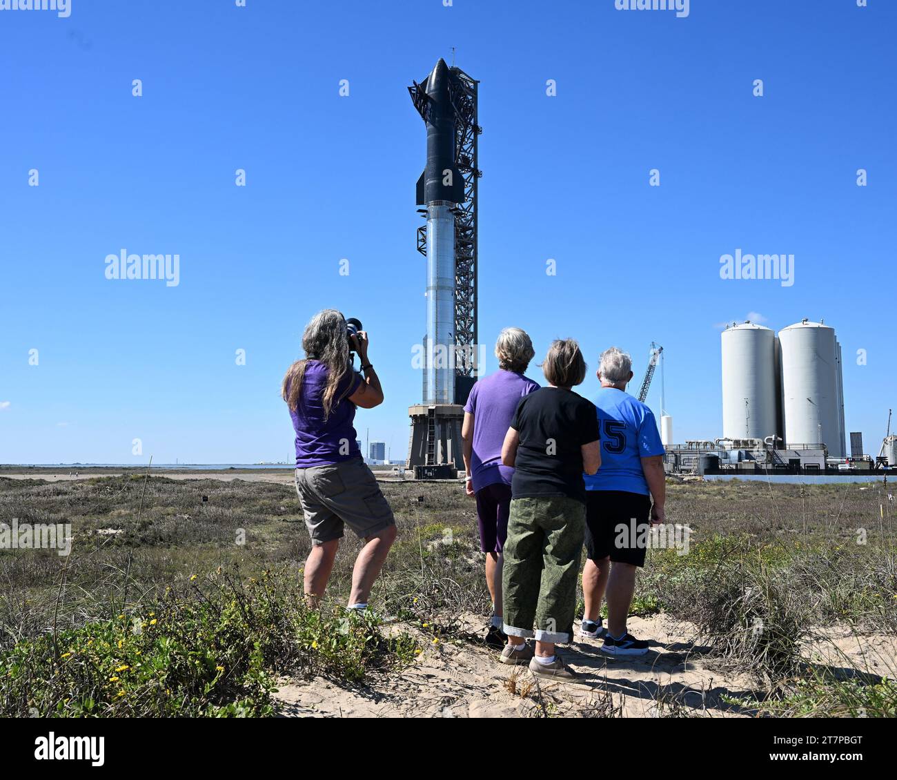 Spectators watch as the SpaceX "Starship" stands on the Super Heavy ...