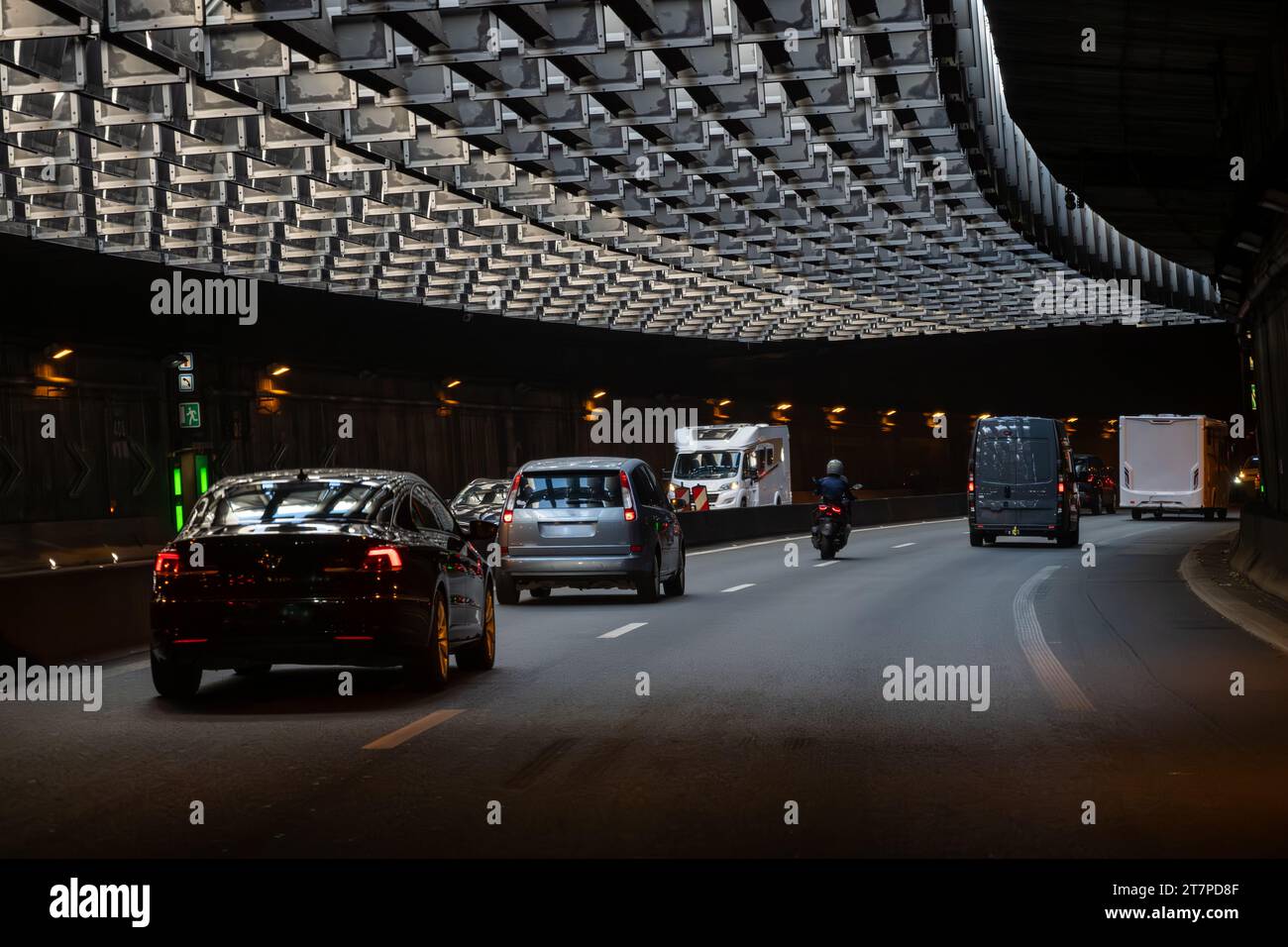 Driving in tunnel in heavy traffic on ring road of capital of France ...