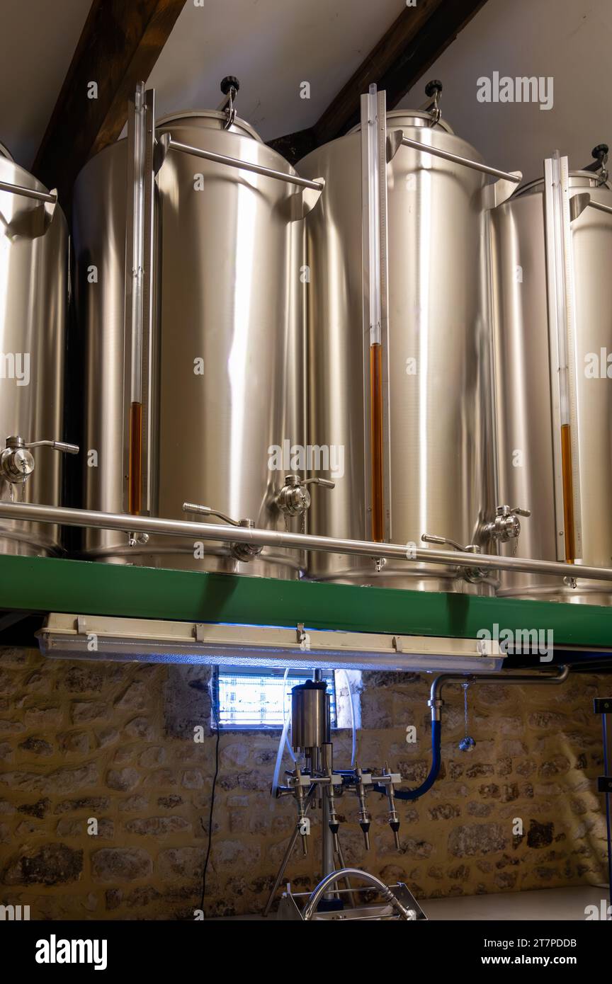 Blending process of cognac spirit and old dark French oak barrels in ...