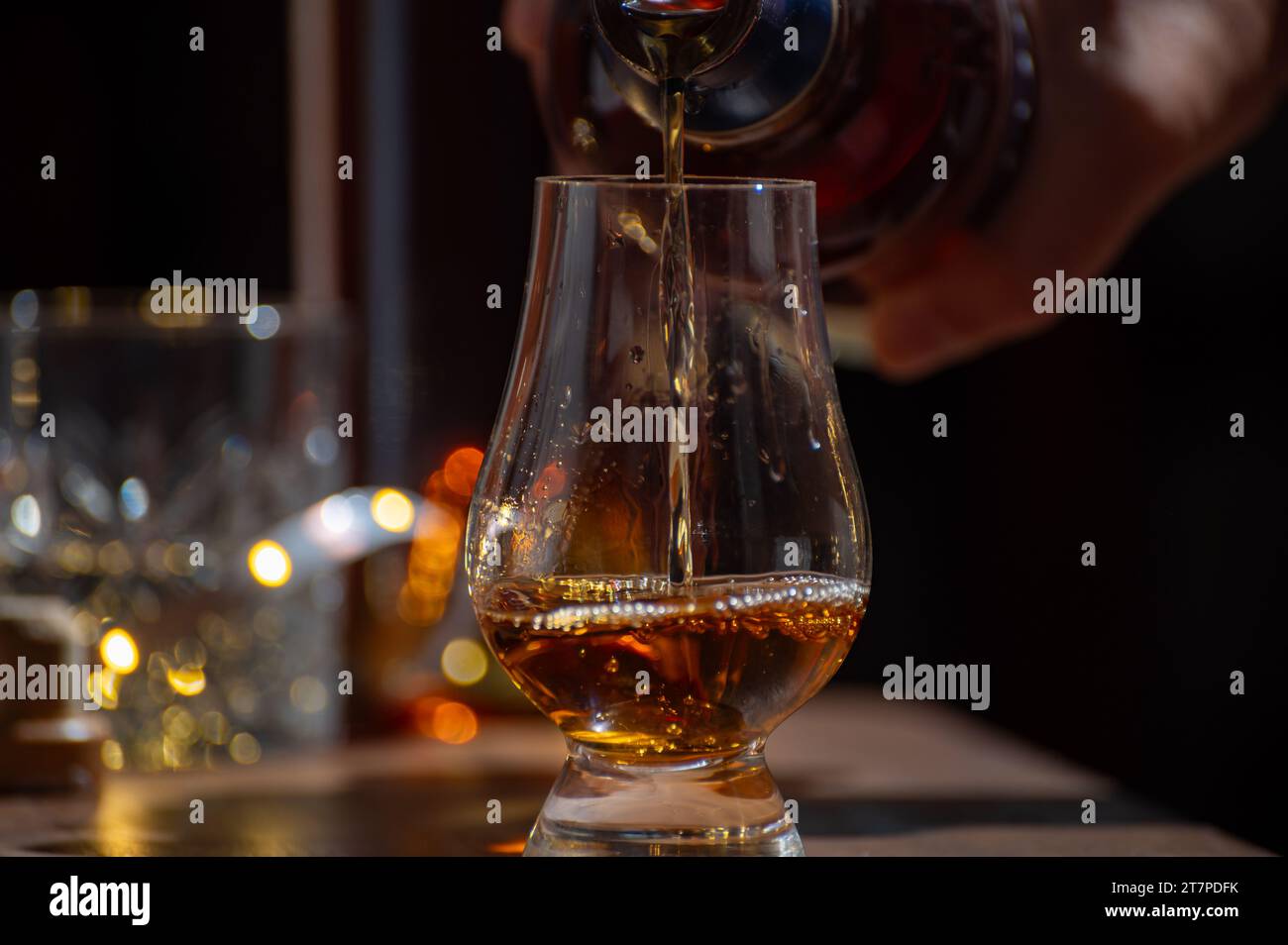 Pouring of whisky, glasses of single malt and blended scotch whisky ...