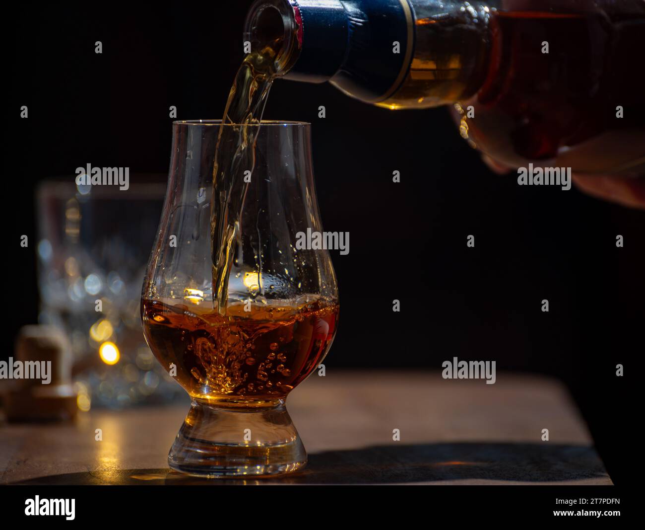 Pouring of whisky, glasses of single malt and blended scotch whisky ...