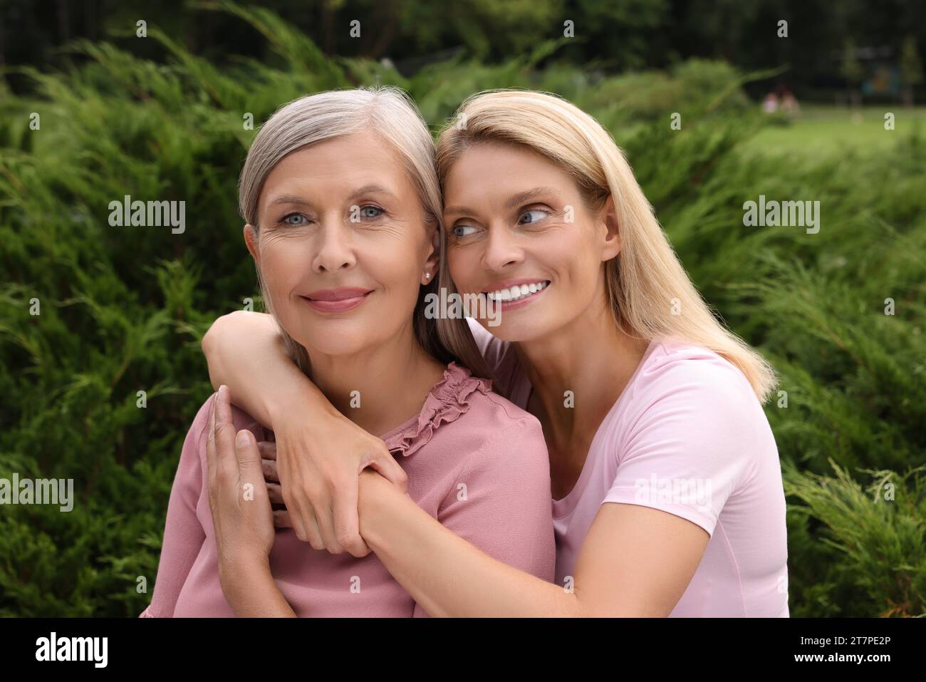 Happy mature mother and her daughter hugging outdoors Stock Photo - Alamy