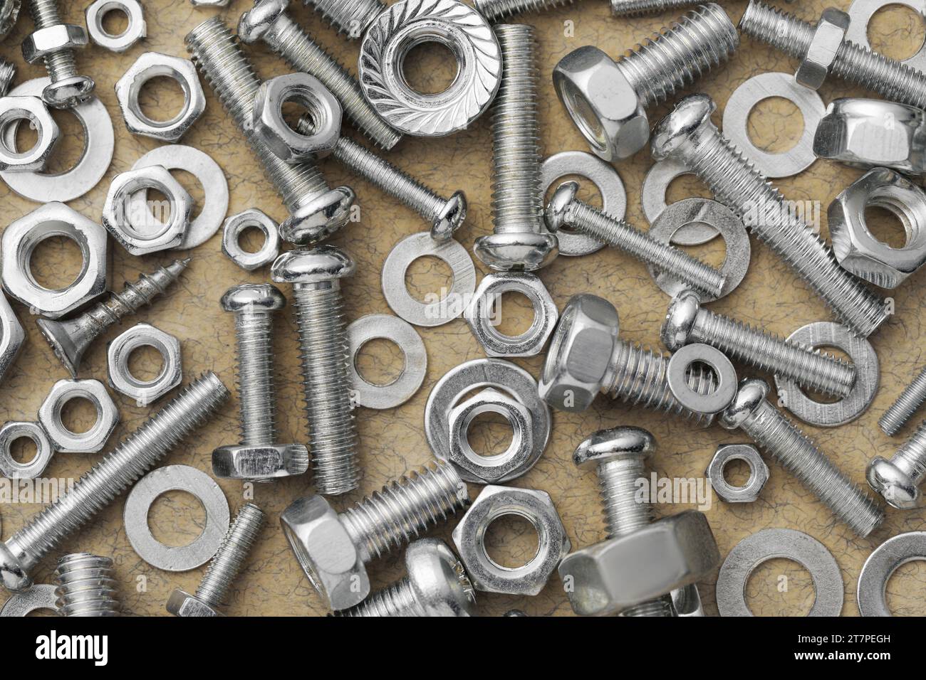 Different metal bolts and nuts on beige textured table, flat lay Stock ...
