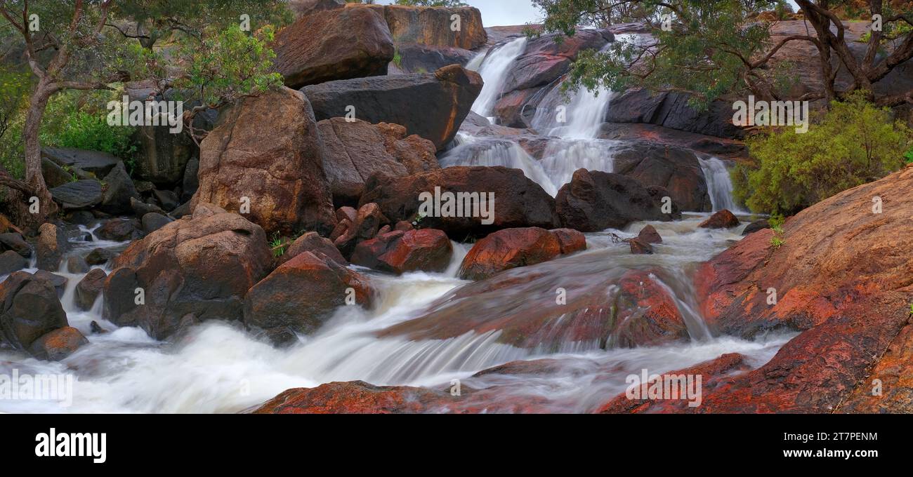 Landscape image of blurred water cascade over red rocks at National ...