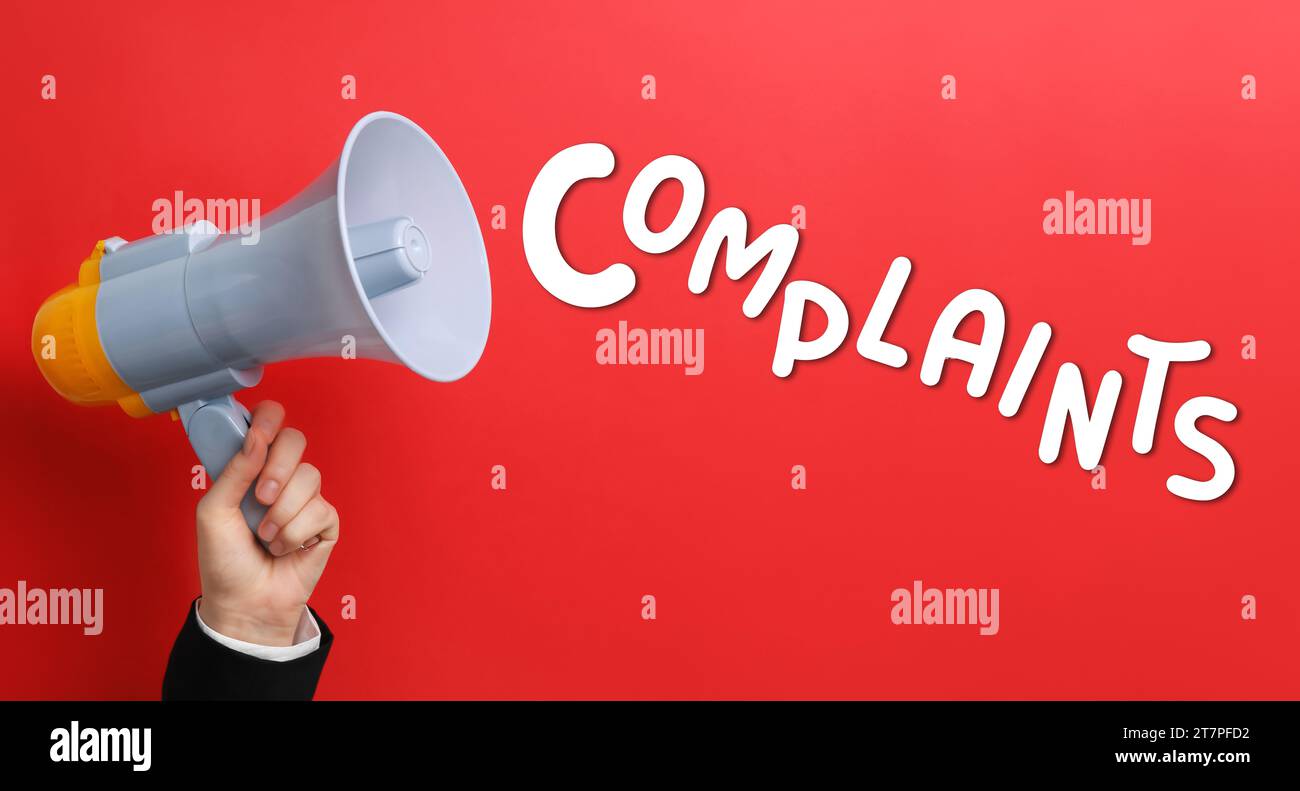 Man holding megaphone on red background, closeup. Word Complaints coming out from device. Banner ...