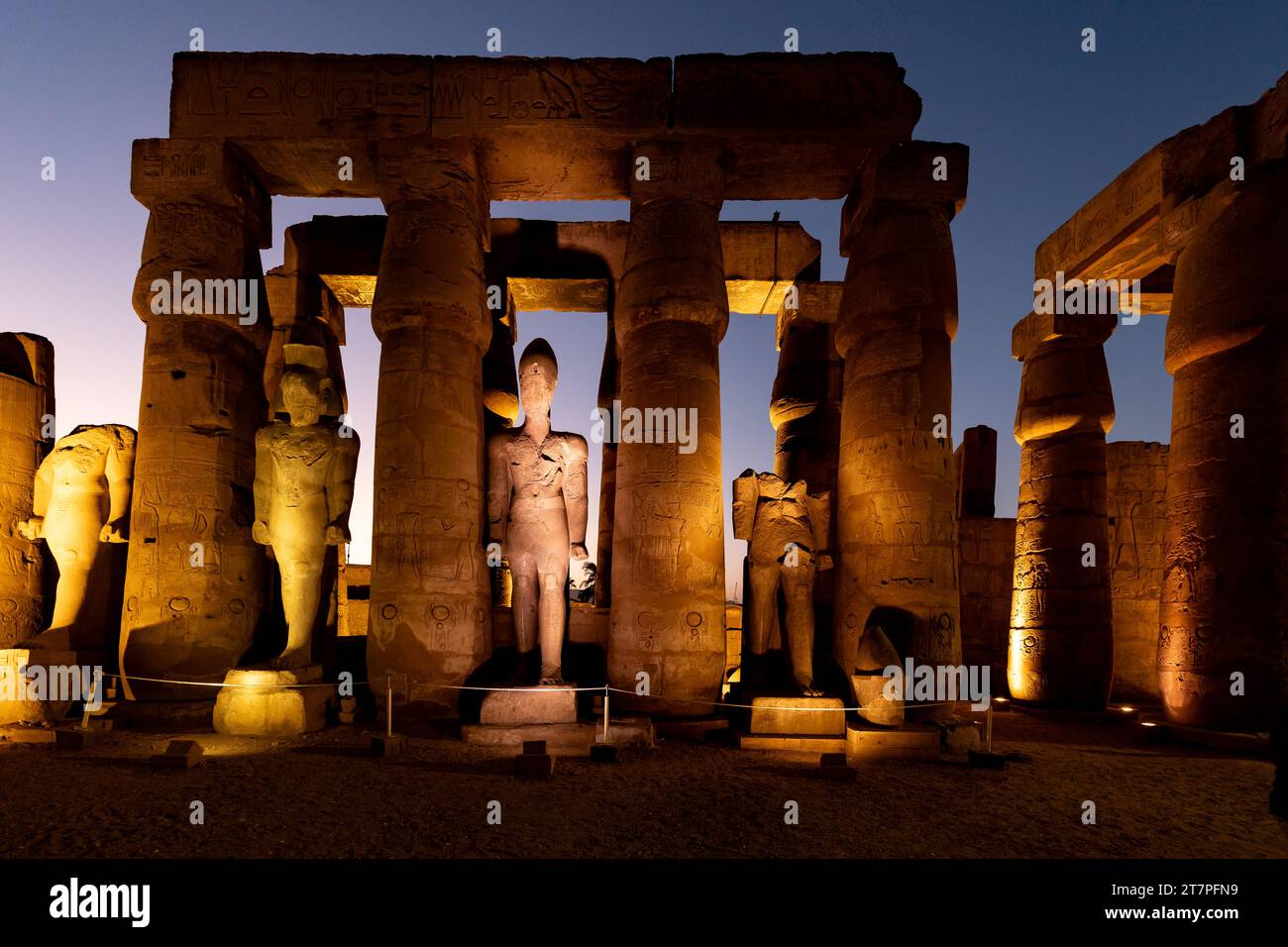 Night view of the statues columns and hieroglyphics of the ...