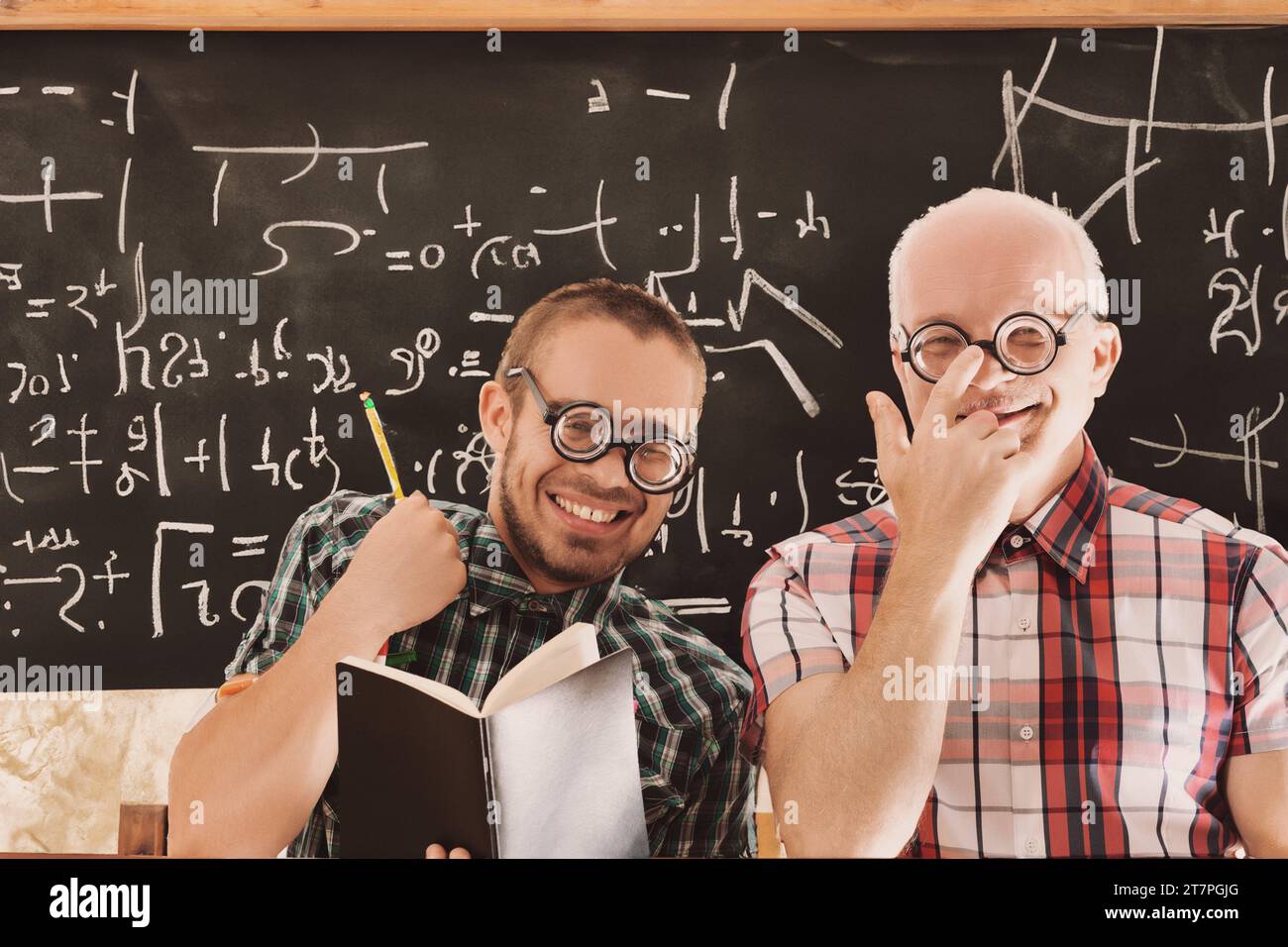 Joyful mathematicians share a humorous moment in a classroom setting ...