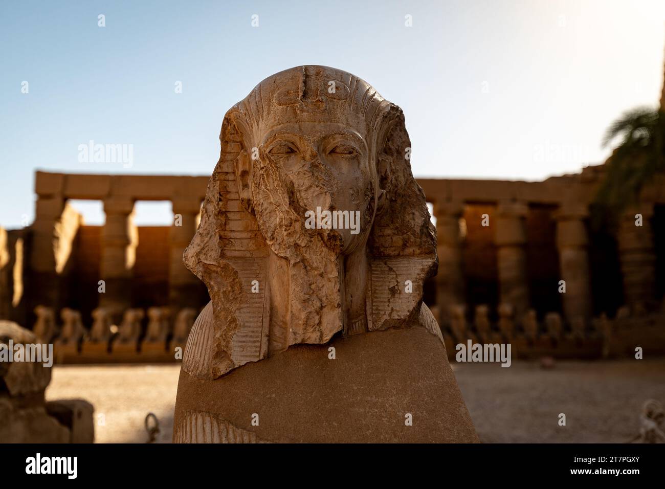 Large stone sphinx statue in the ancient ruins of Karnak Temple complex ...