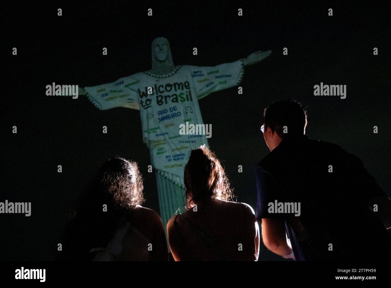 Fans look up at the Christ the Redeemer statue that is illuminated with ...
