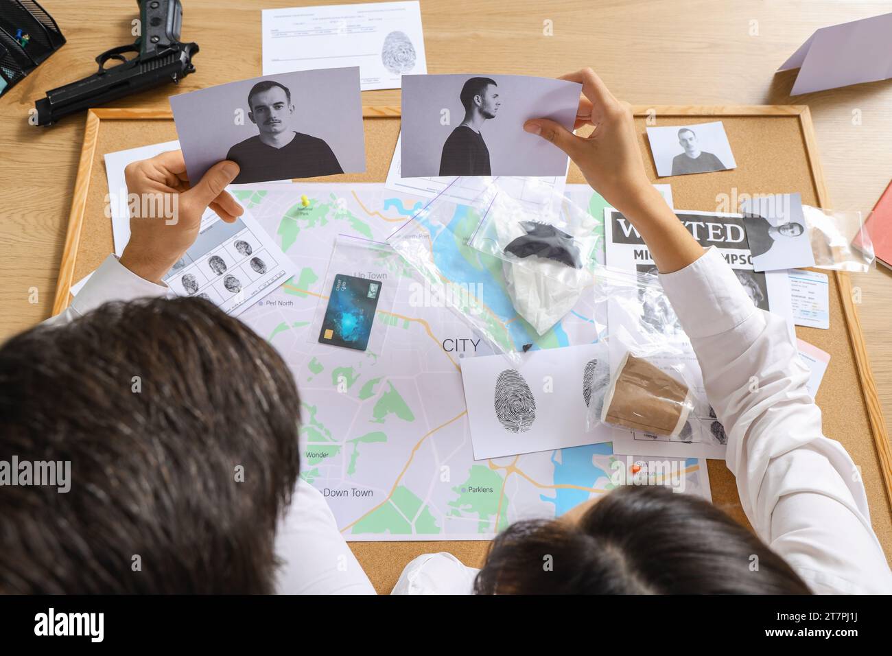 FBI agents with pictures of suspects investigating case in office, top ...