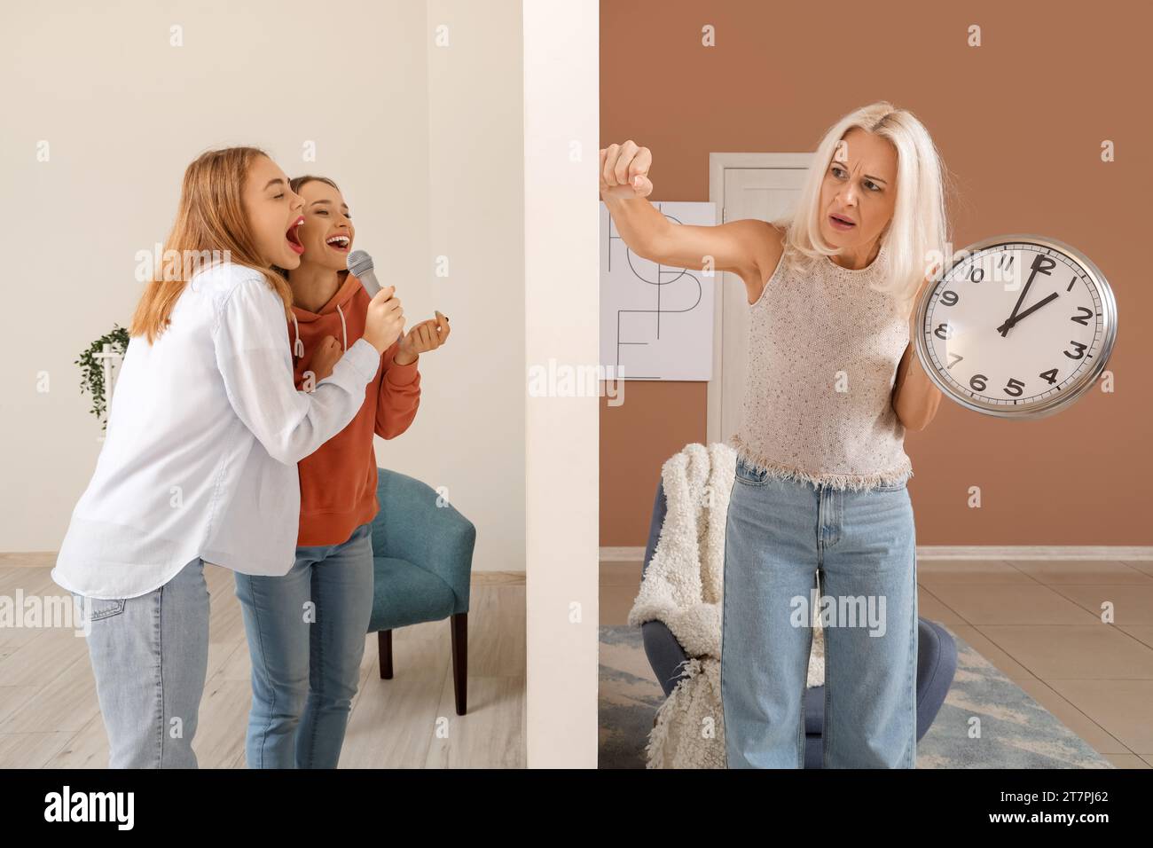 Mature woman with clock suffering from loud neighbours singing at home ...