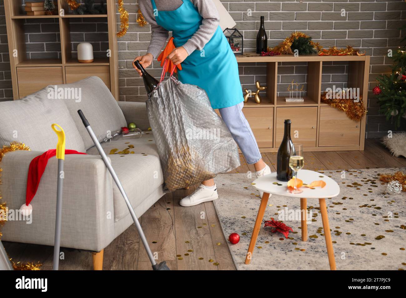 Female janitor cleaning in messy living room after New Year party Stock ...
