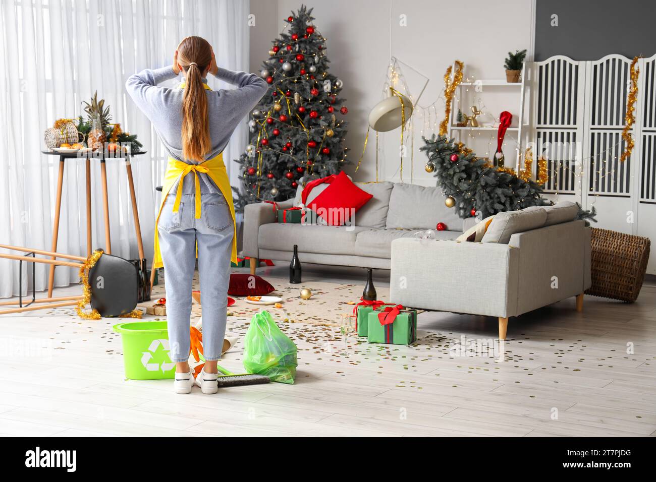 Shocked female janitor in messy living room after New Year party, back ...