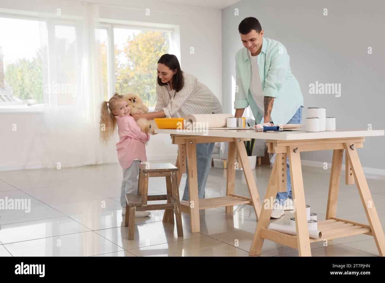 Happy family during repair of their new house Stock Photo - Alamy