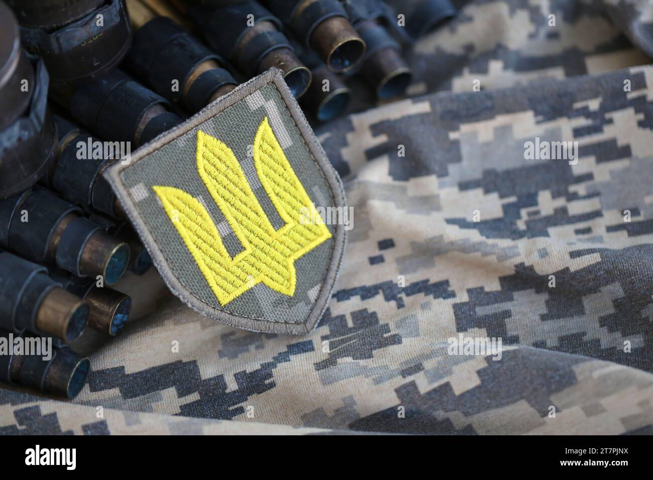 Ukrainian army symbol on machine gun belt lies on ukrainian pixeled ...
